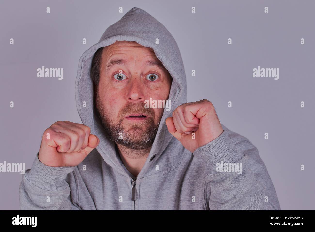 Man in tracksuit top stood in a boxing stance.Model release available ...