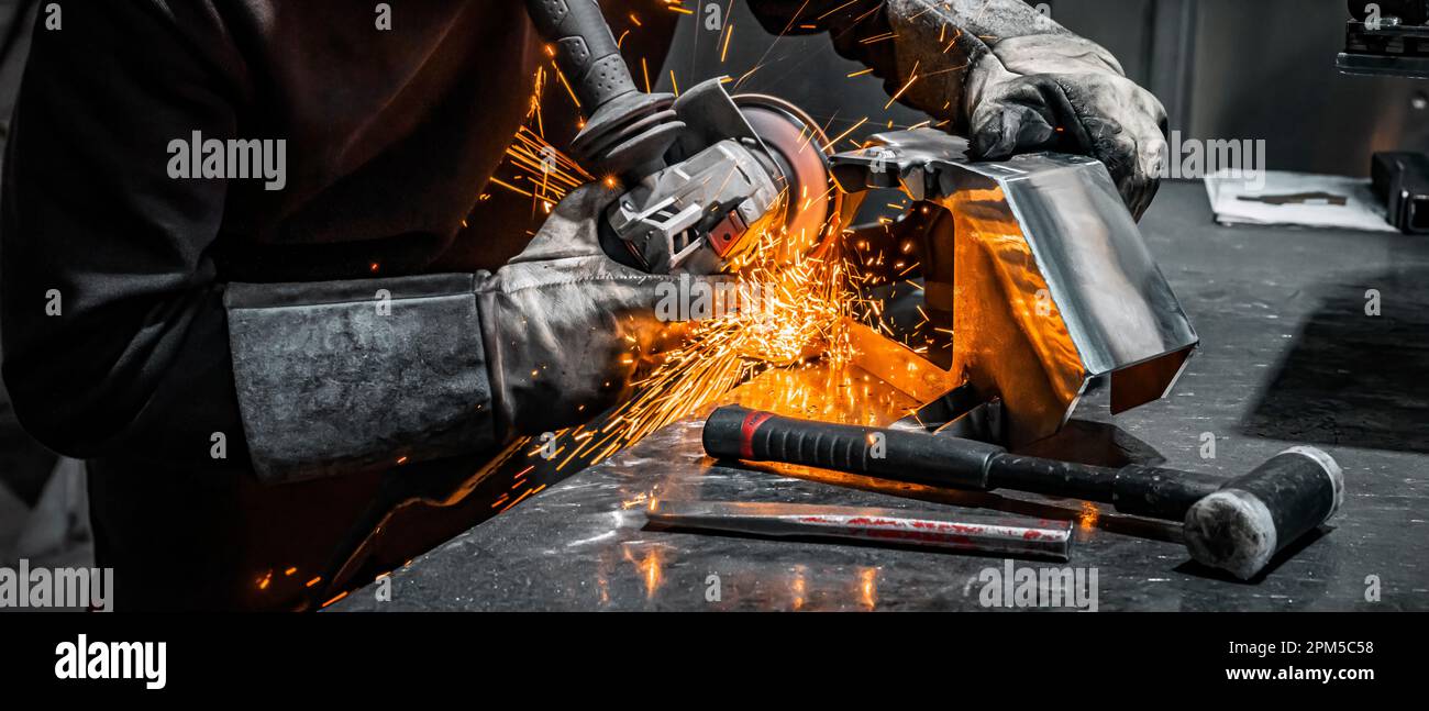 worker grinding a piece of metal, France Stock Photo - Alamy