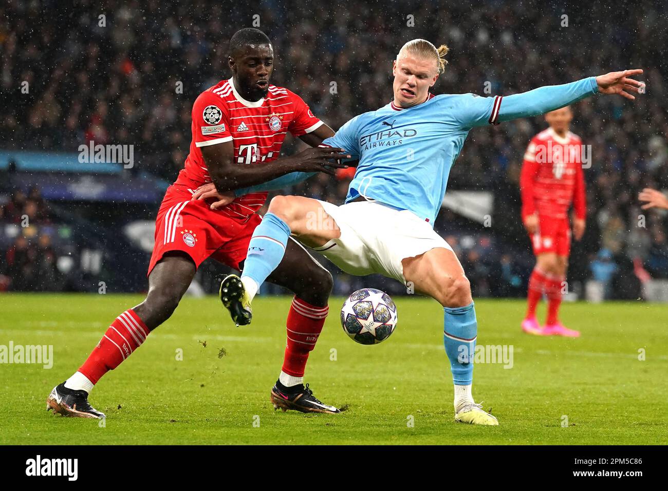 Manchester City's Erling Haaland (right) and Bayern Munich's Dayot ...