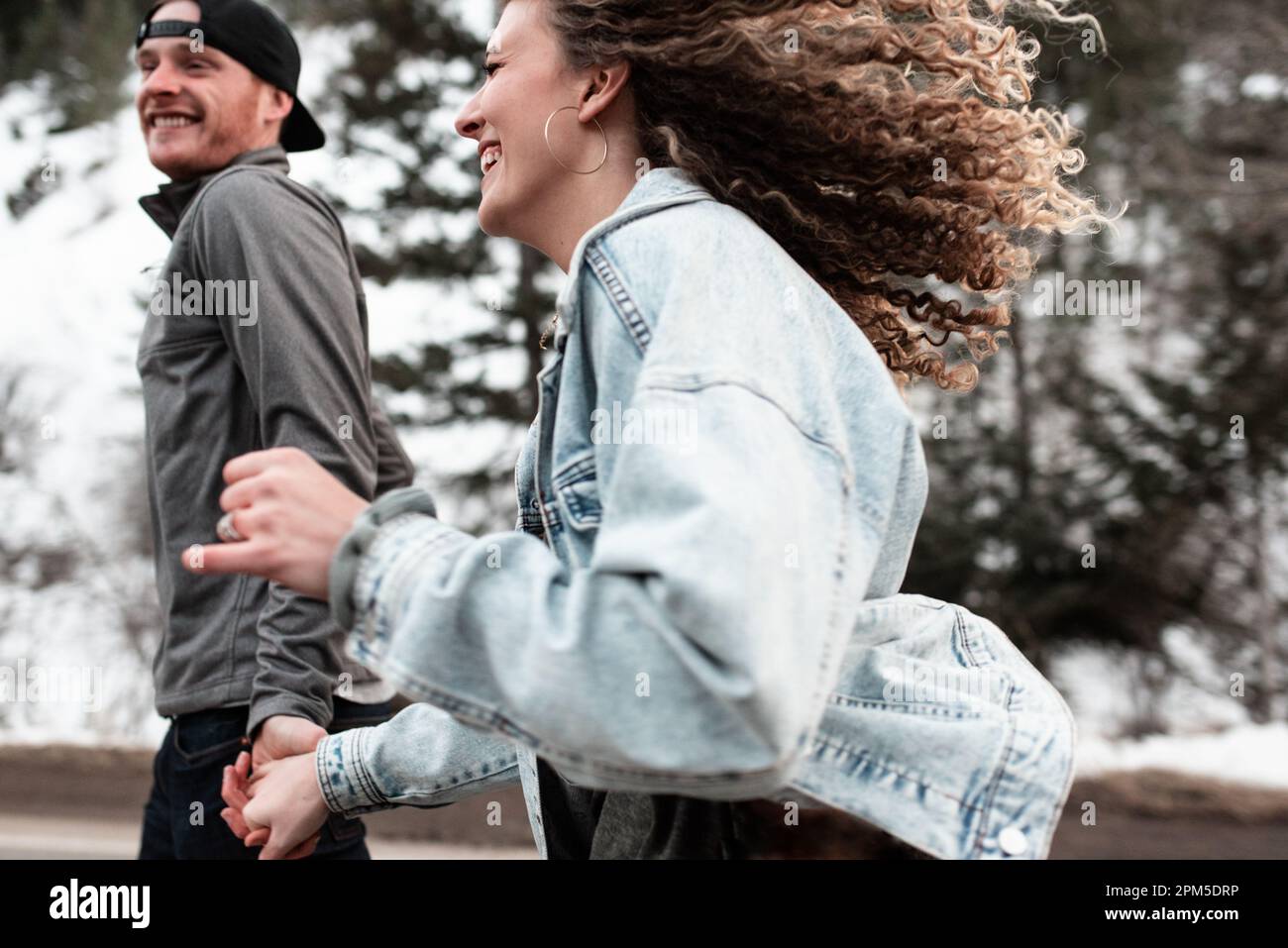 Adventurous Couple Happily Running in Colorado Mountains in Winter ...