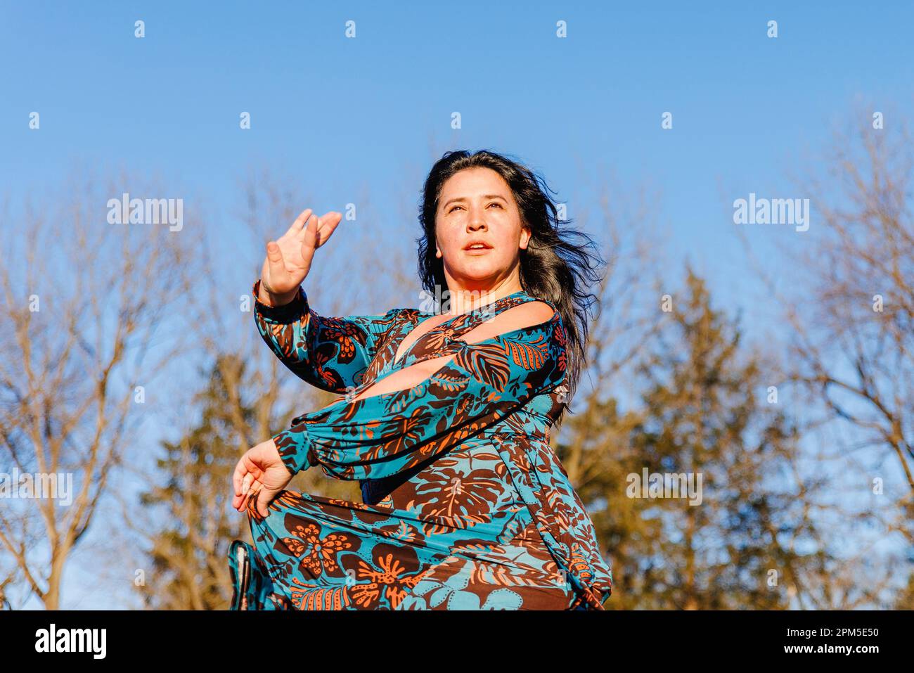 A beautiful intense woman dances flamenco outside Stock Photo - Alamy
