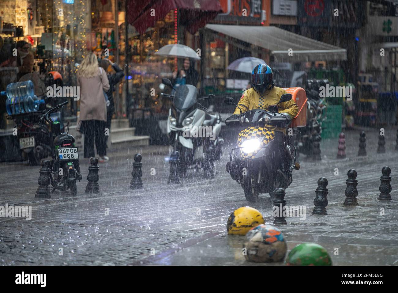 Istanbul, Turkey. 11th Apr, 2023. A motor courier rides in the heavy ...