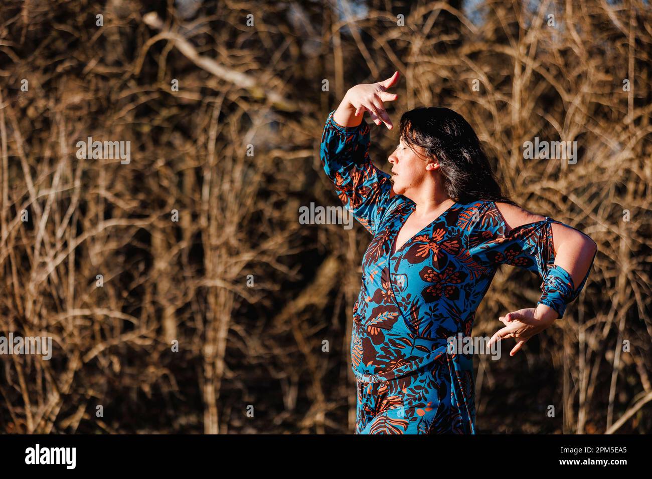 A passionate woman dances flamenco outside in sunlight Stock Photo - Alamy