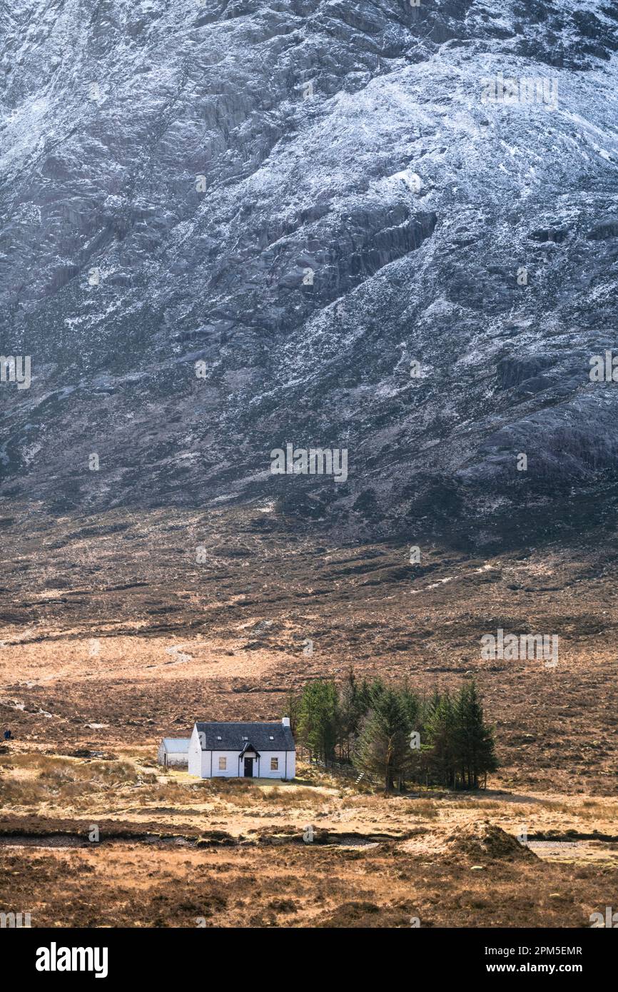 Lone white country against a tall mountain in the Scottish Highlands ...