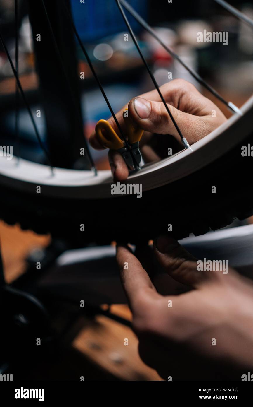 Closeup vertical cropped shot of unrecognizable repairman using tool to ...