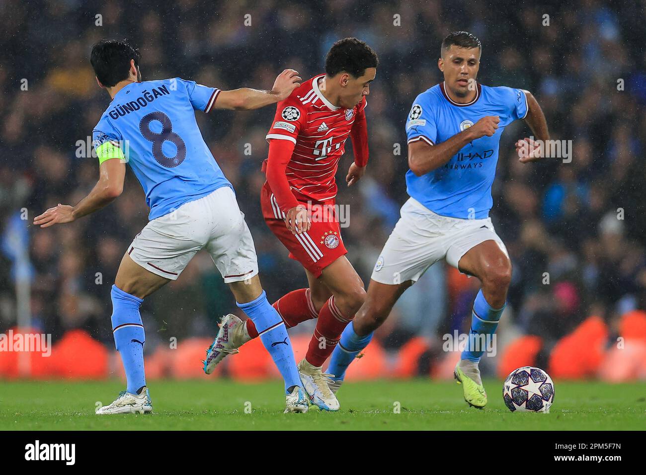 Jamal Musiala #42 of Bayern Munich is challenged by Rodri #16 of ...