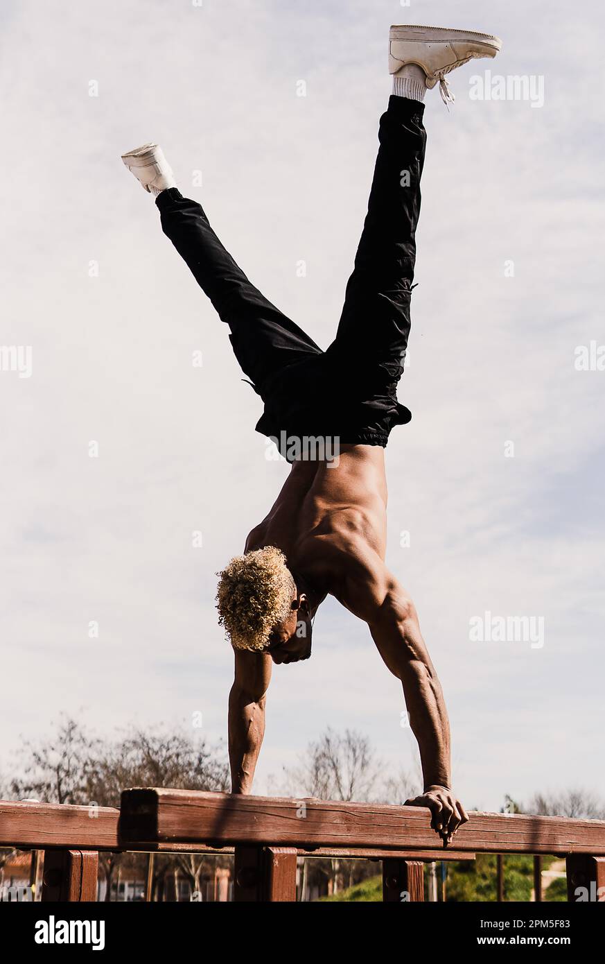 Black man doing calisthenics in a park. Man doing a handstand Stock ...