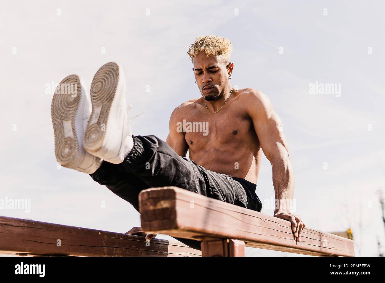 Stock photo of black man doing calisthenics in a park Stock Photo - Alamy