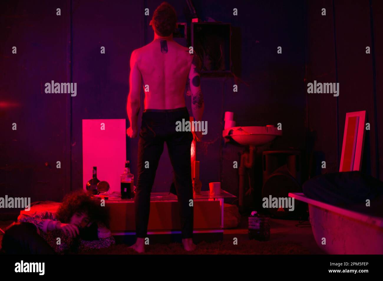 Young man standing with his back backstage movie shoot Stock Photo - Alamy