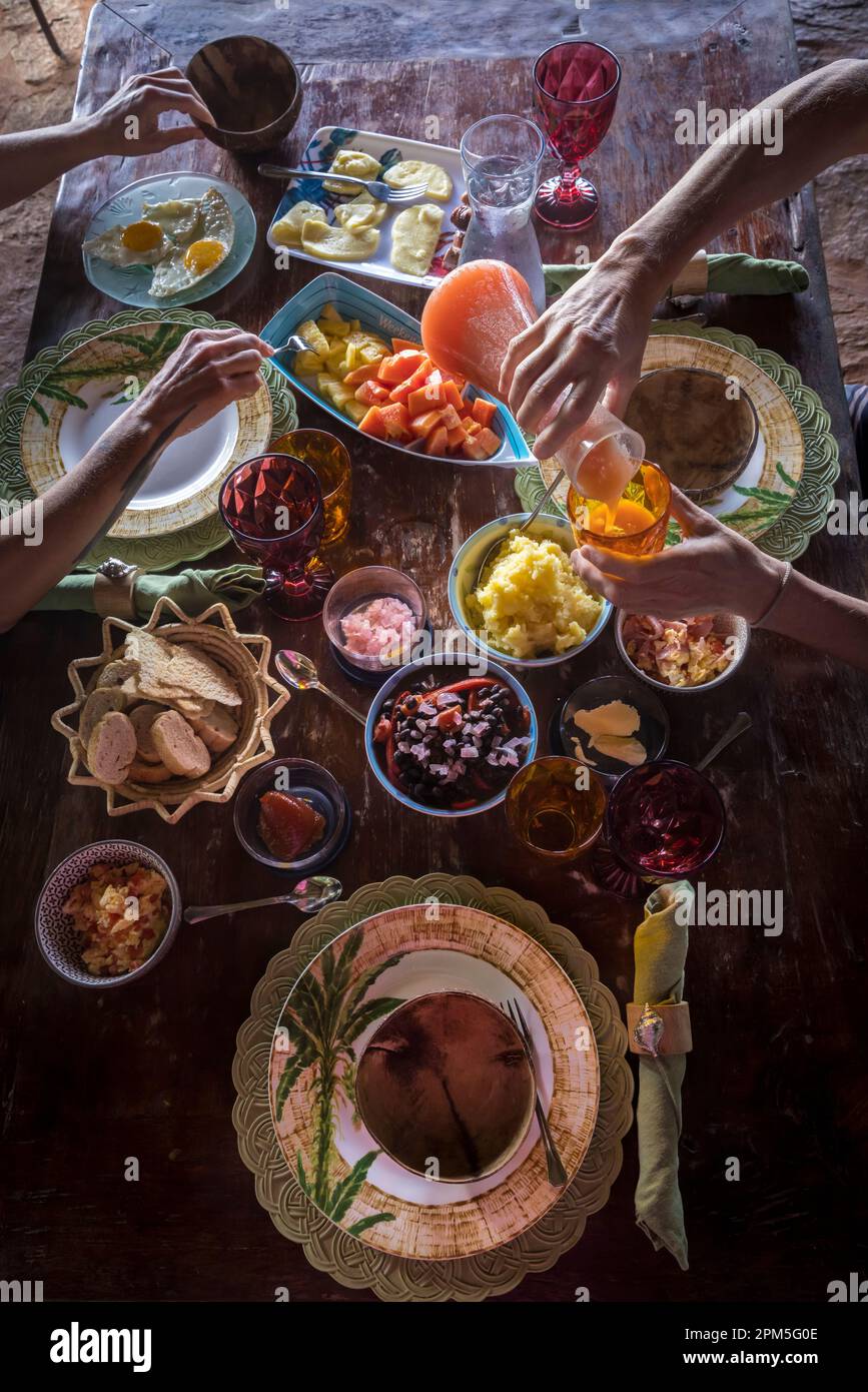 overhead view of hands serving healthy breakfast on wooden table Stock ...