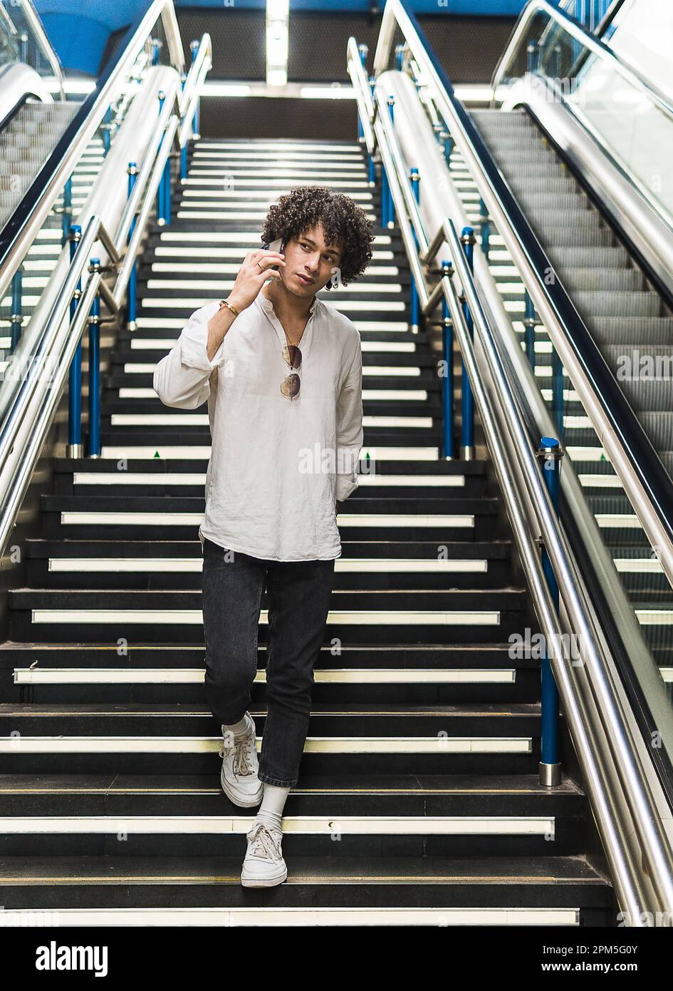 stock photo of latin business man speaking by his phone in the subway ...