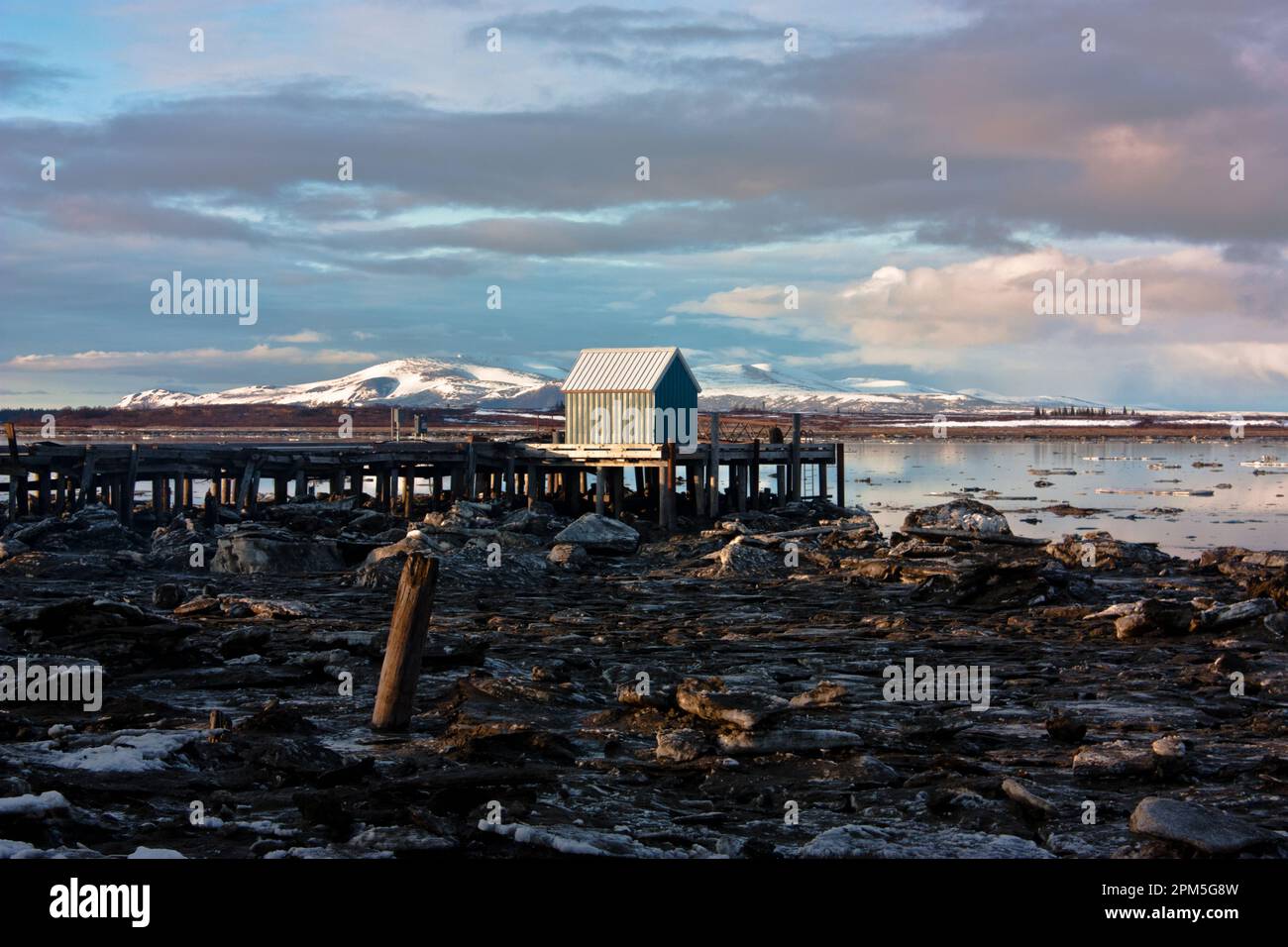 Dock Shack on an Alaskan Beach with Snow and Ice Stock Photo - Alamy