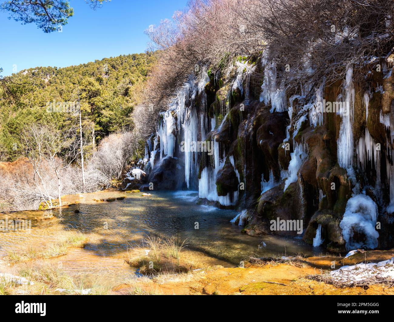 Semi-frozen waterfall at the end of winter thaw at the source of the ...