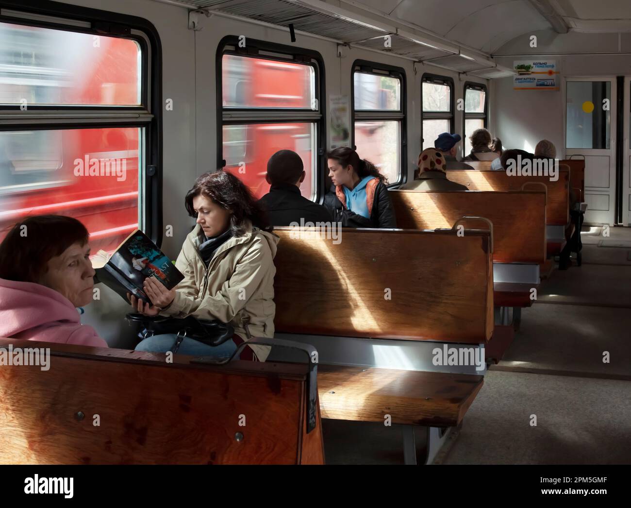 People riding the train on a sunny day Stock Photo - Alamy