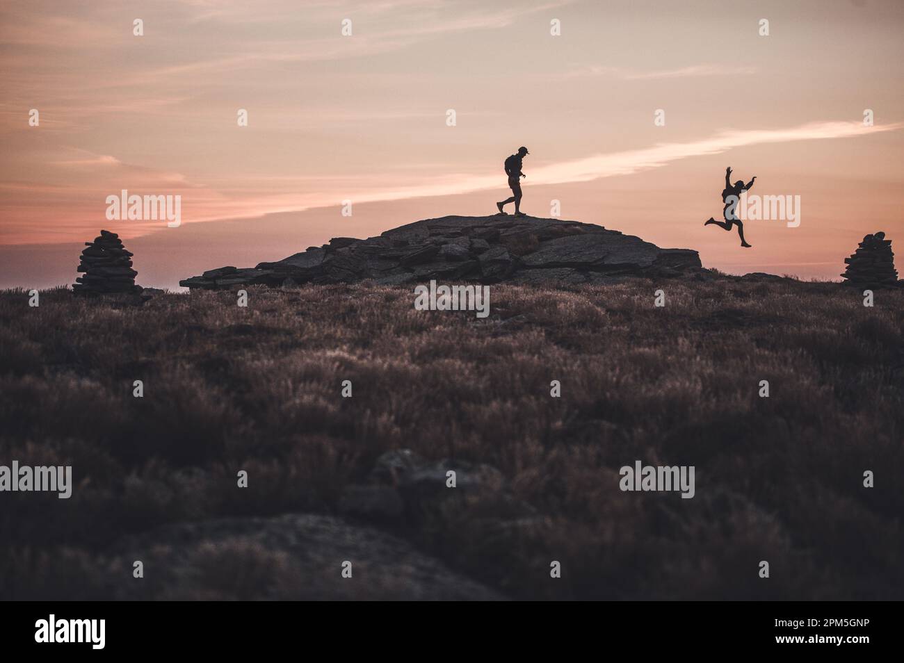 Silhouette male trail runners running over ridge at dawn sunrise Stock ...