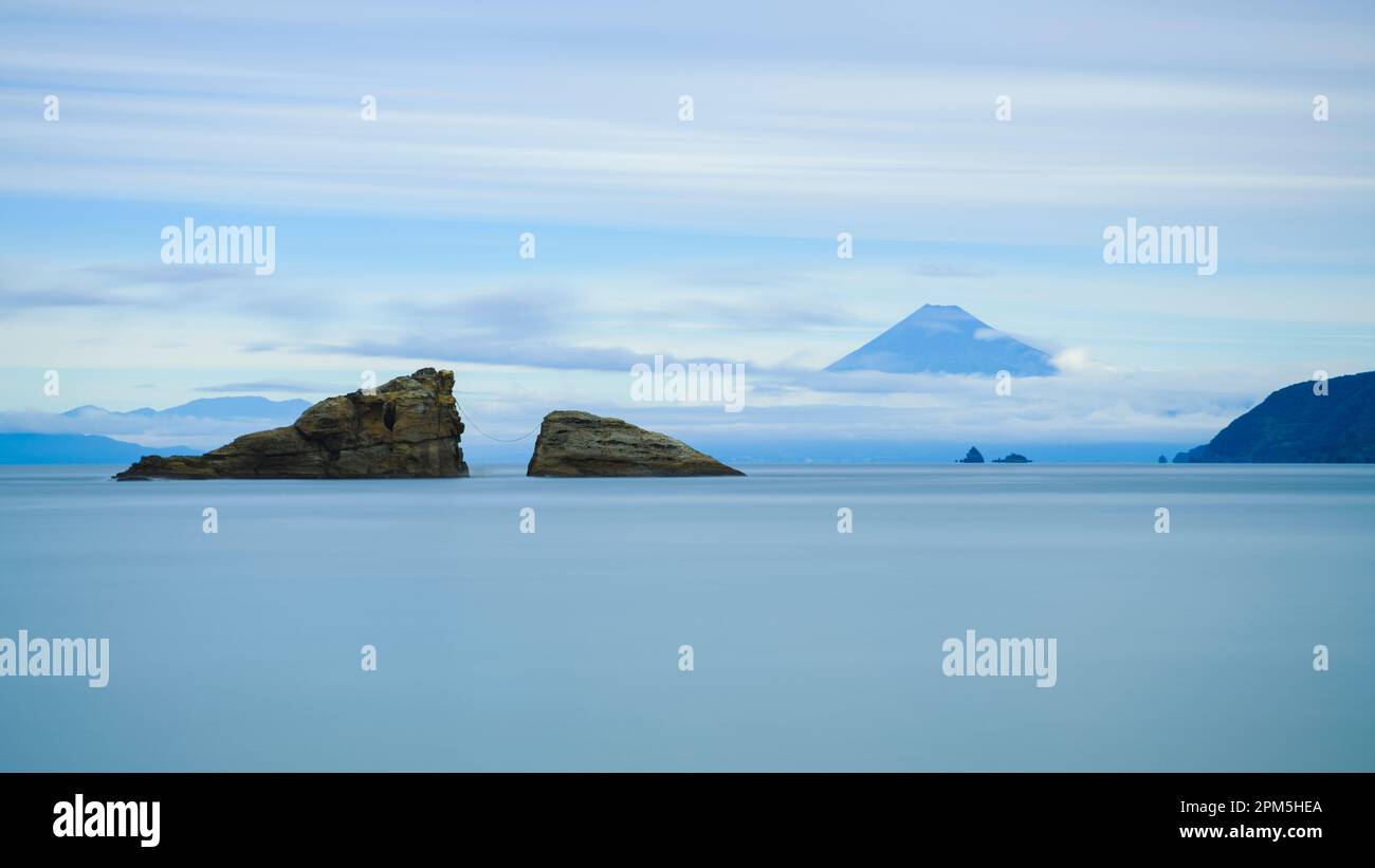 Long exposure shot of sea stacks in the water and Mount Fuji Stock ...