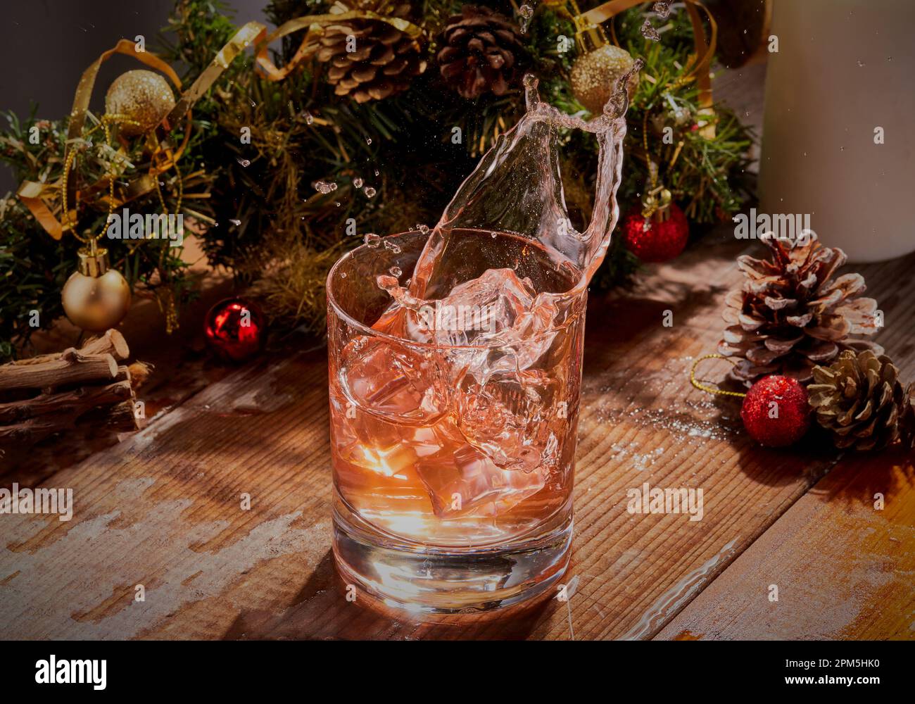 Christmas drink splash shot with festive decorations in the background ...