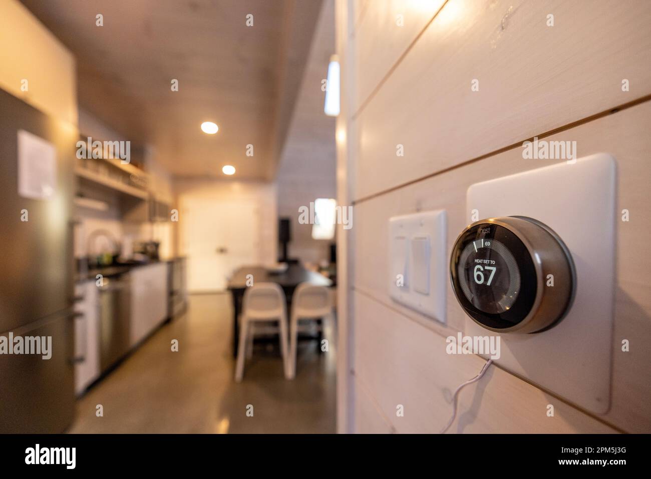 detail of a digital thermostat mounted on wall reading the temperature ...