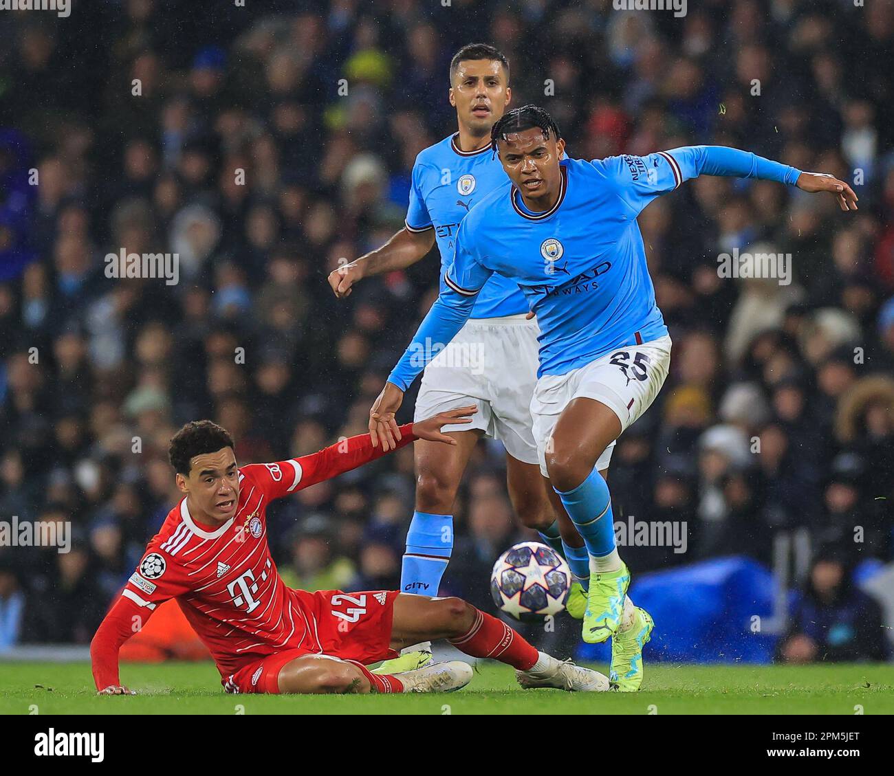 Manuel Akanji #25 of Manchester City evades the challenge of Jamal ...