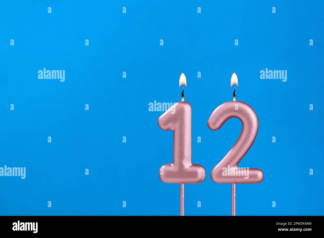 Candle number 12 - Birthday in blues foamy background Stock Photo - Alamy