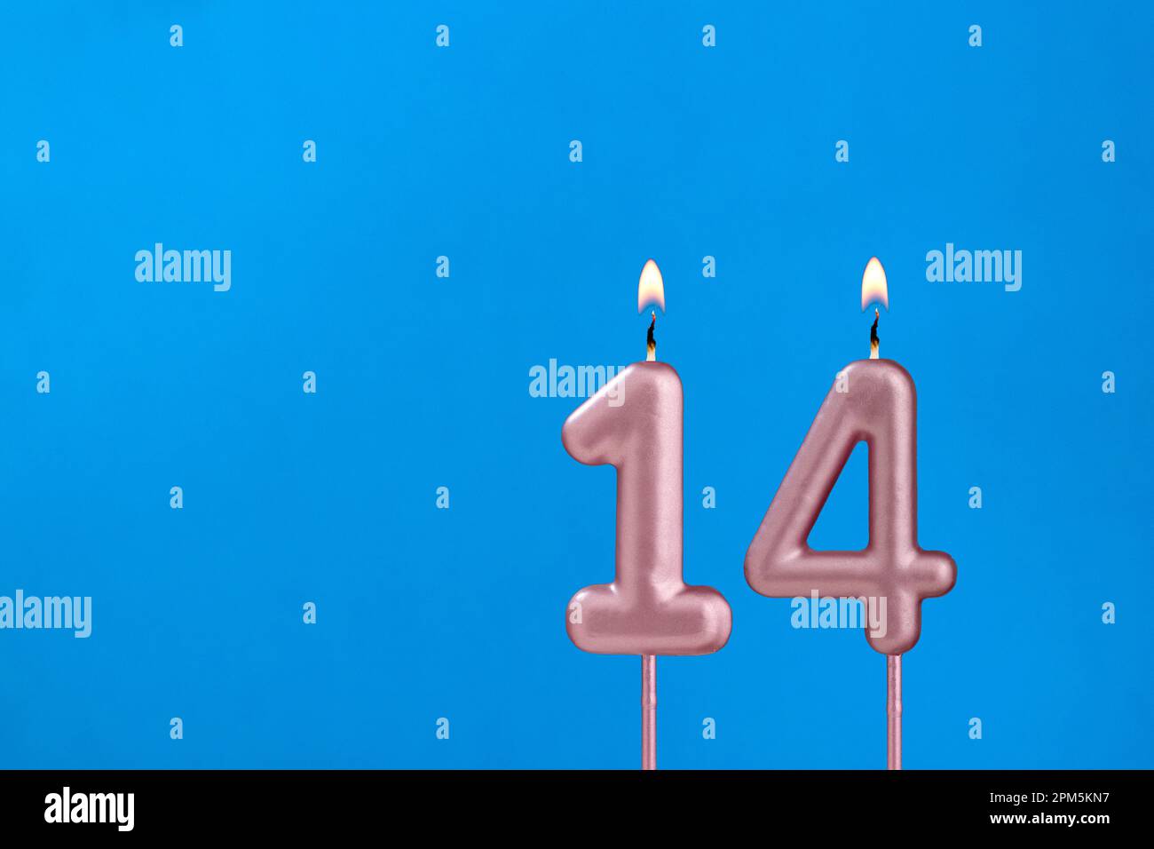 Candle number 14 - Birthday in blues foamy background Stock Photo - Alamy
