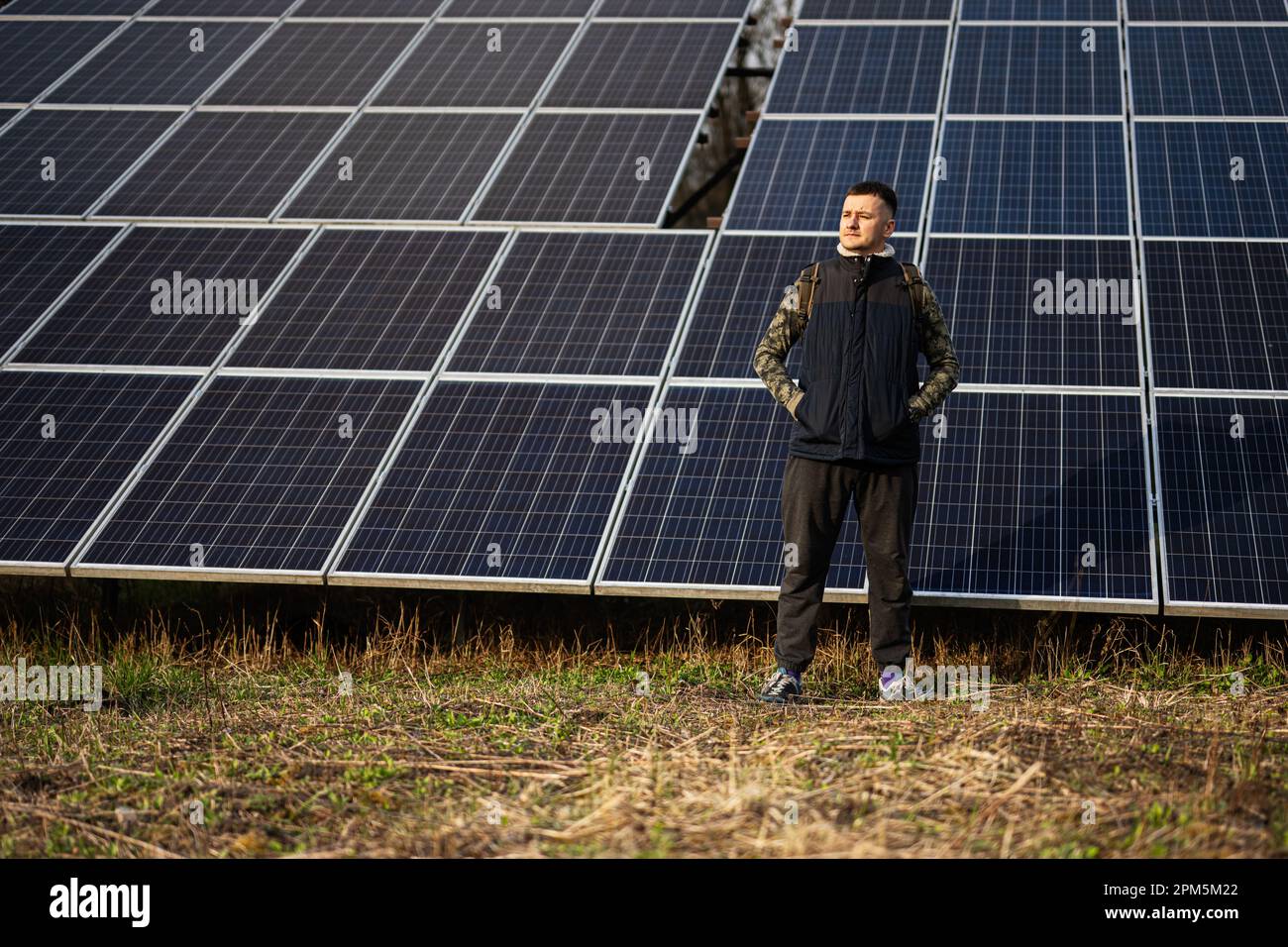 Man on the background of solar panels. Eco energy Stock Photo - Alamy