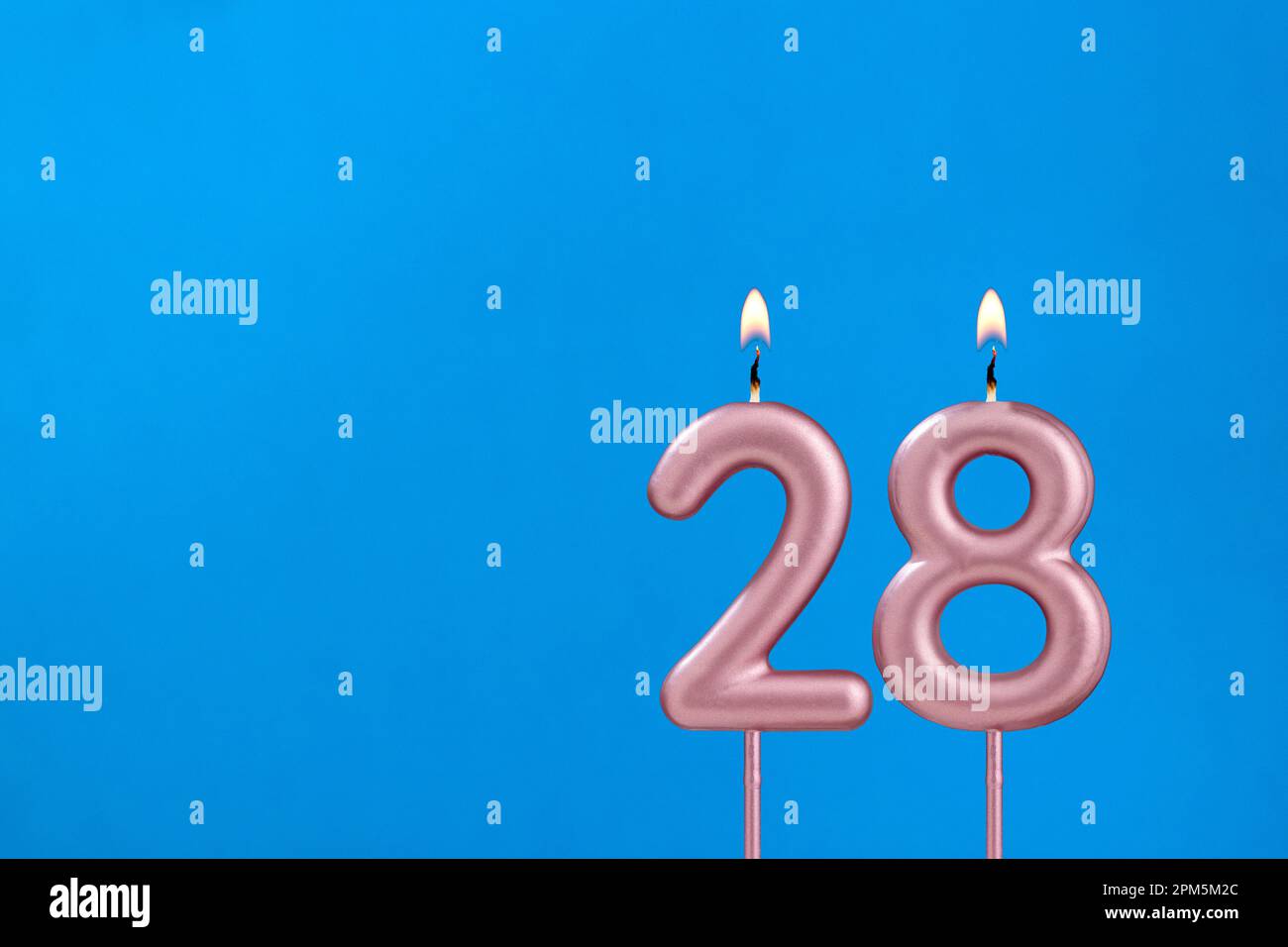 Candle number 28 - Birthday in blues foamy background Stock Photo - Alamy