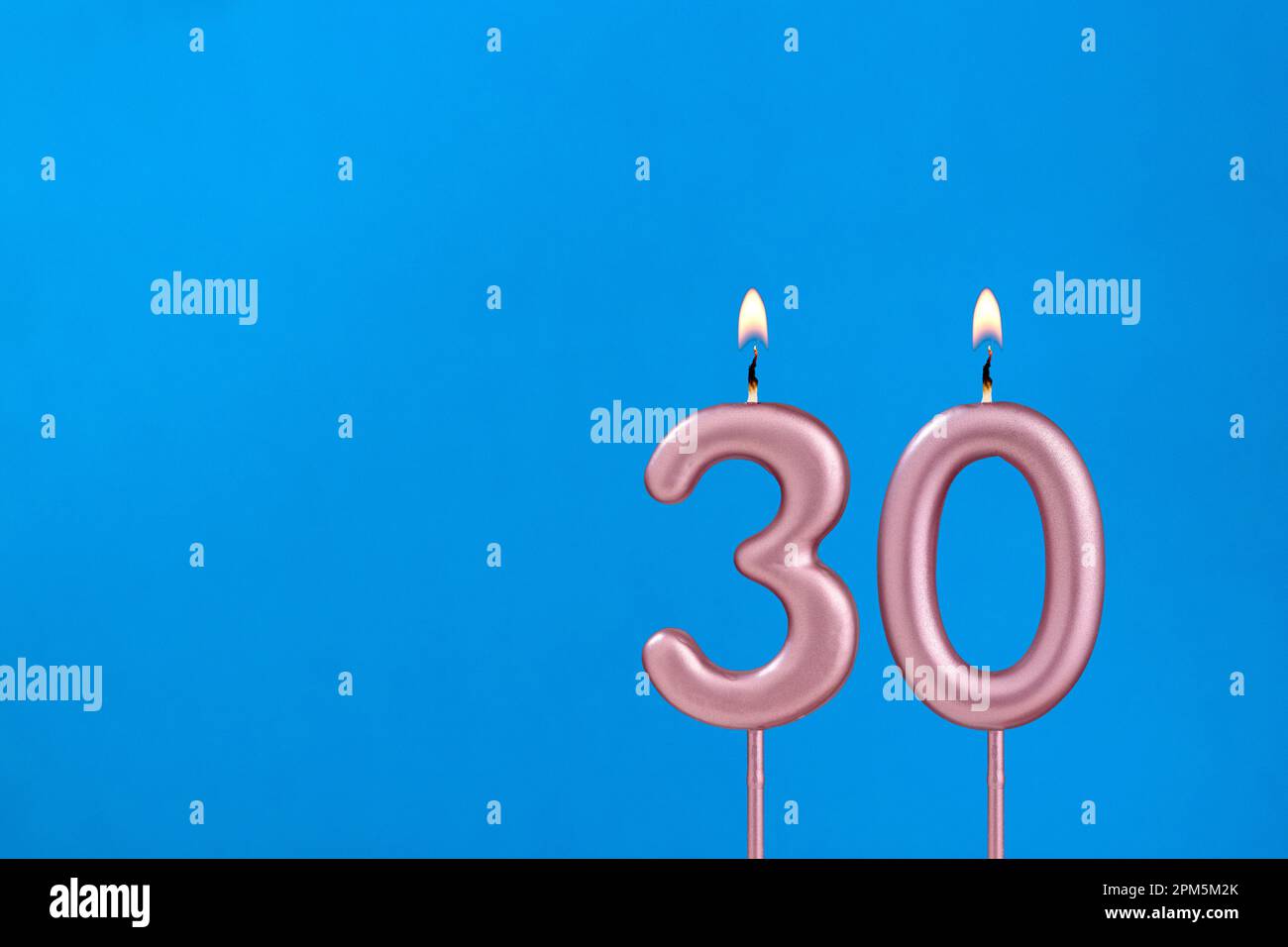 Candle number 30 - Birthday in blues foamy background Stock Photo - Alamy