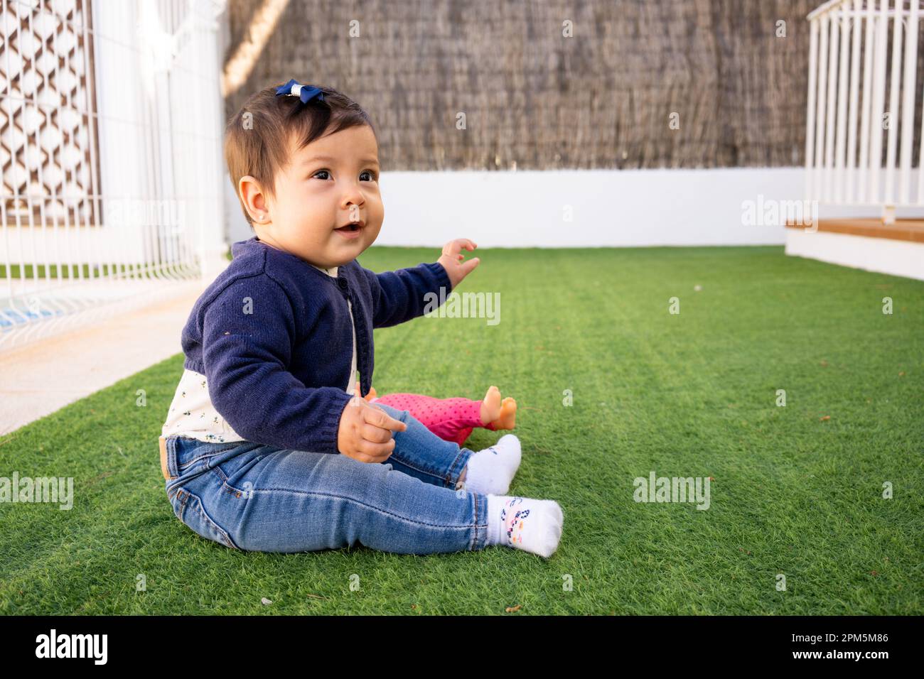 Adorable little baby girl with cute smile sitting unsupported and ...