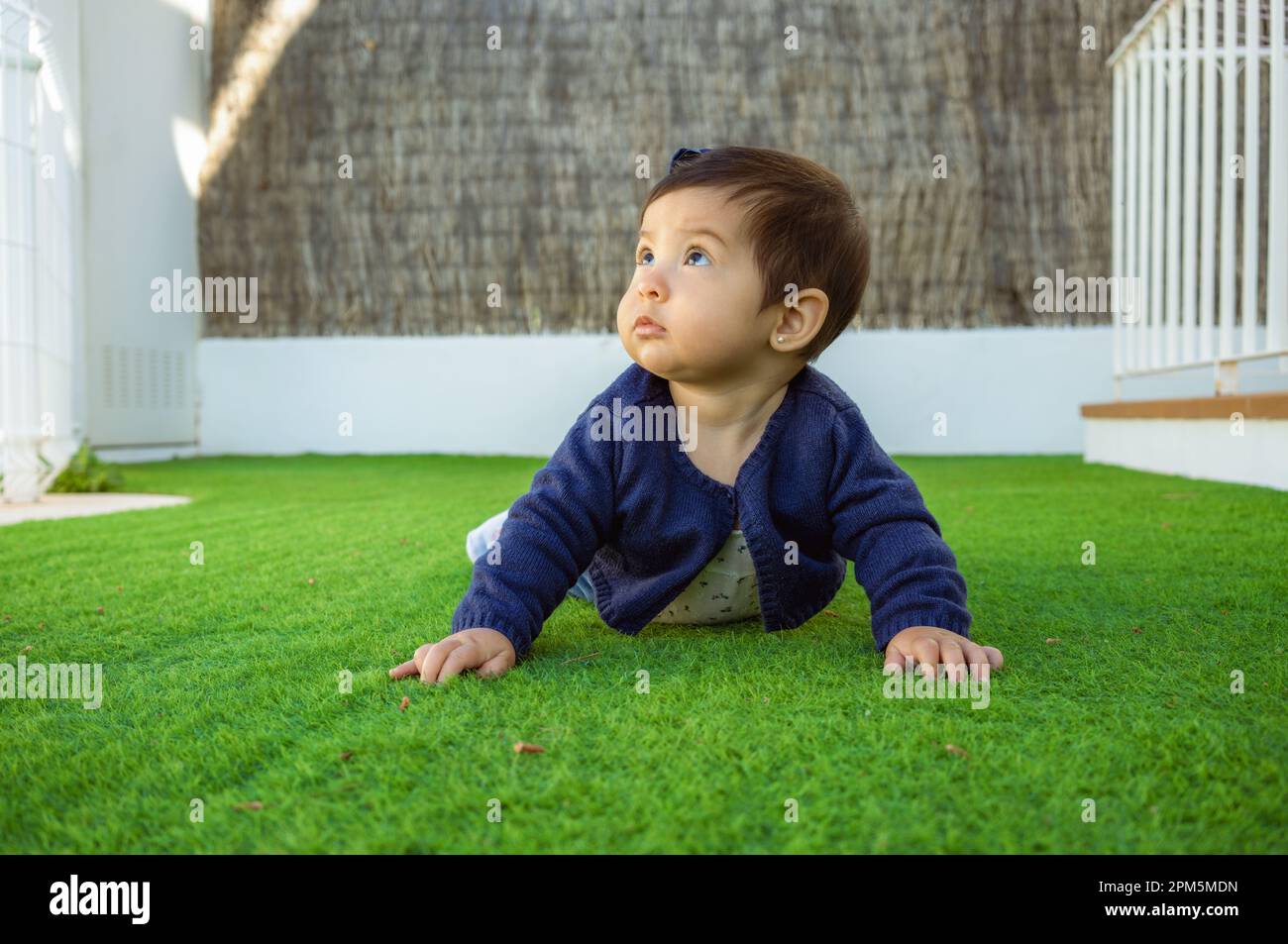 Adorable little baby girl with cute smile sitting unsupported and ...