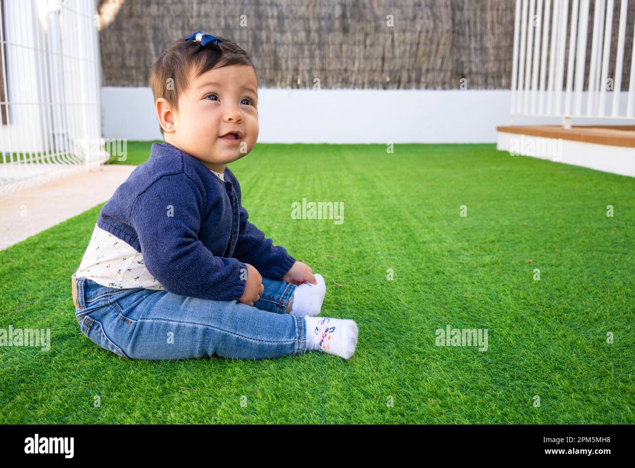 Adorable little baby girl with cute smile sitting unsupported and ...