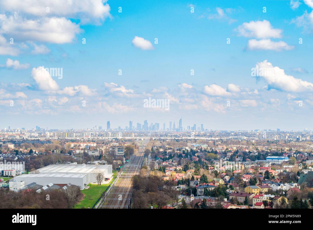 Panorama of the distant center of Warsaw city under the blue cloudy sky ...