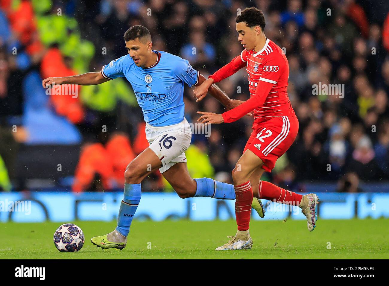 Rodri #16 of Manchester City holds off Jamal Musiala #42 of Bayern ...