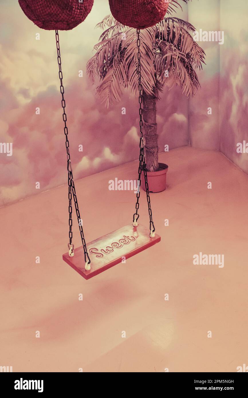 Pink swing on an interior dreaming decoration Stock Photo - Alamy