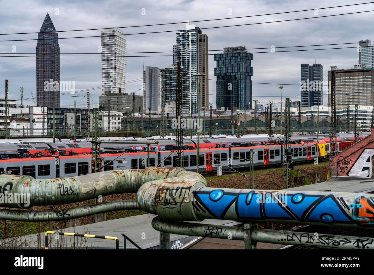 Mainova district heating pipeline, local trains on the track in front ...