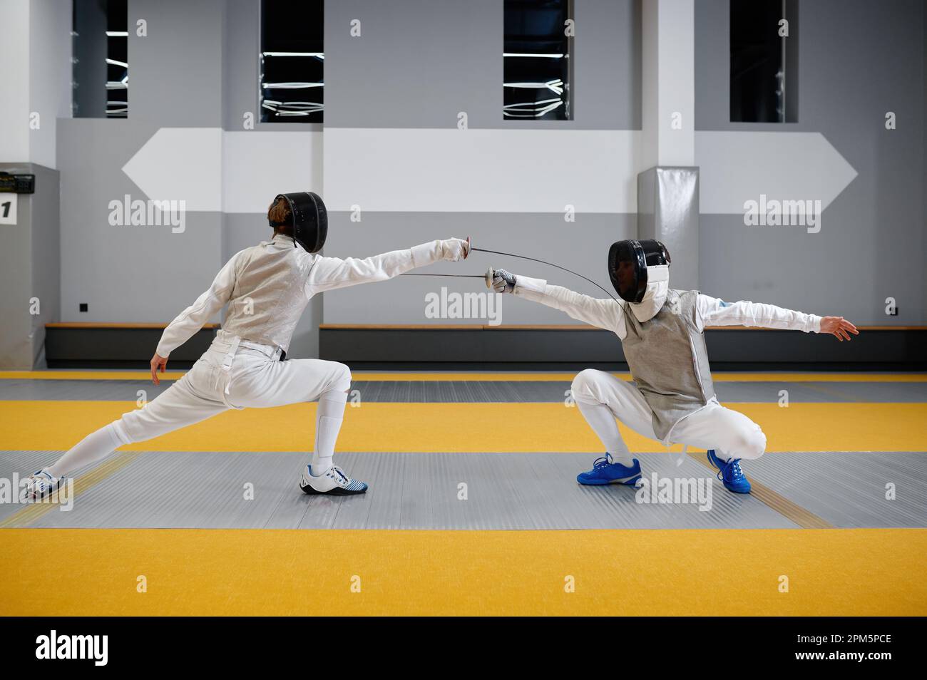 Duel of fencers during fencing match, training lesson at martial art ...