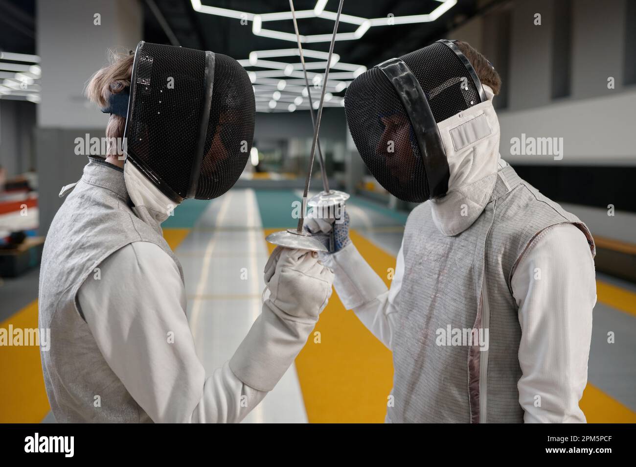Two fencers crossed swords before fight, closeup shot of fencing dual ...
