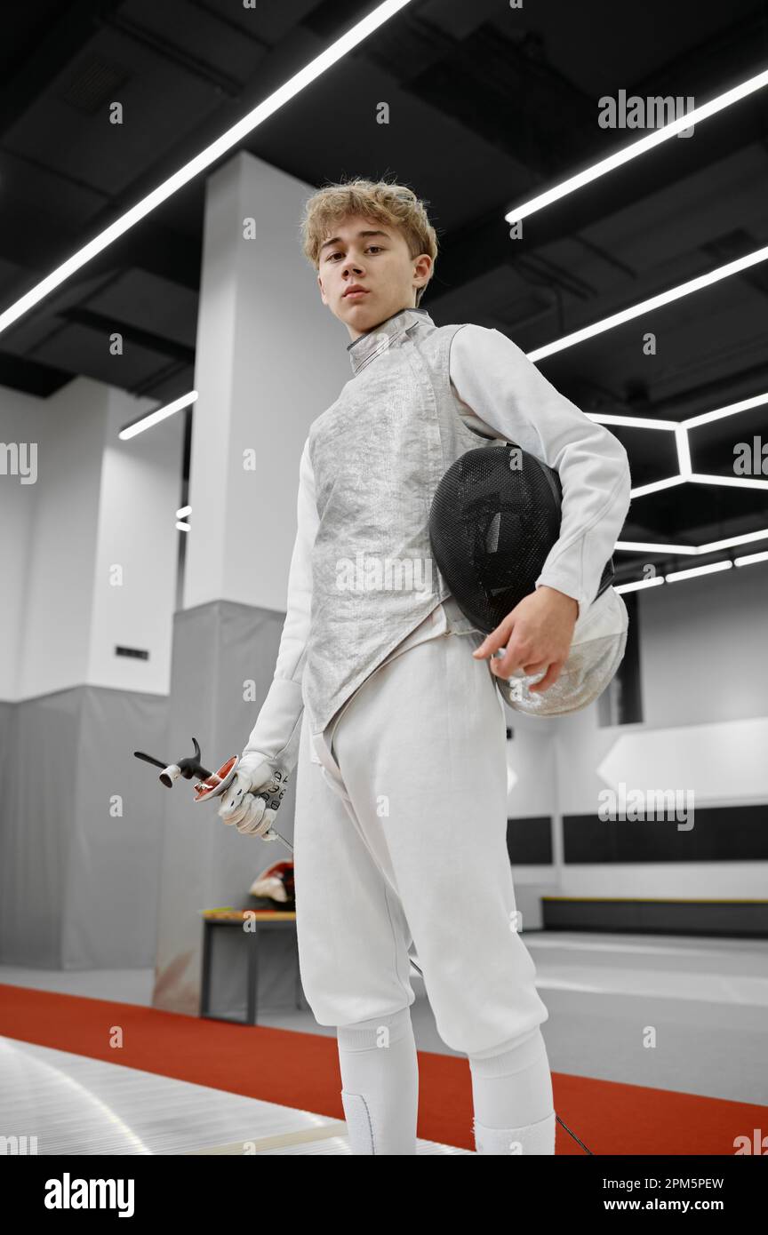 Teenage boy fencer wearing uniform and holding sword portrait Stock ...
