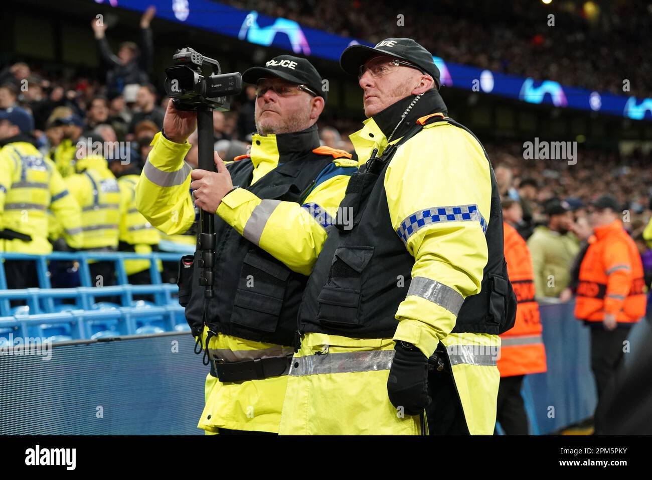Police with a video camera recording the fans during the UEFA Champions ...