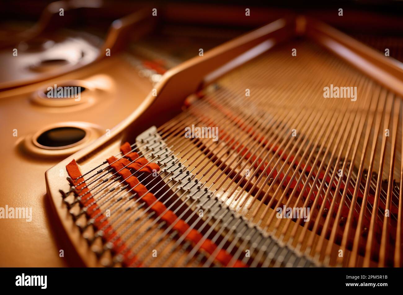 Selective focus closeup view on hammers and strings inside grand piano ...