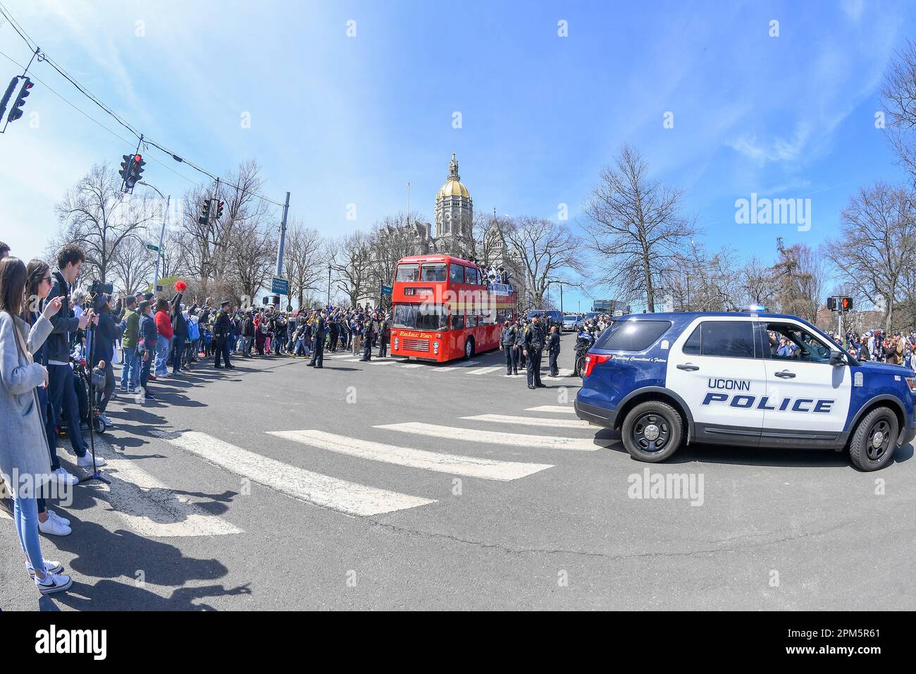 HARTFORD, CT - APRIL 08: UConn Police and an open-top bus with UConn ...
