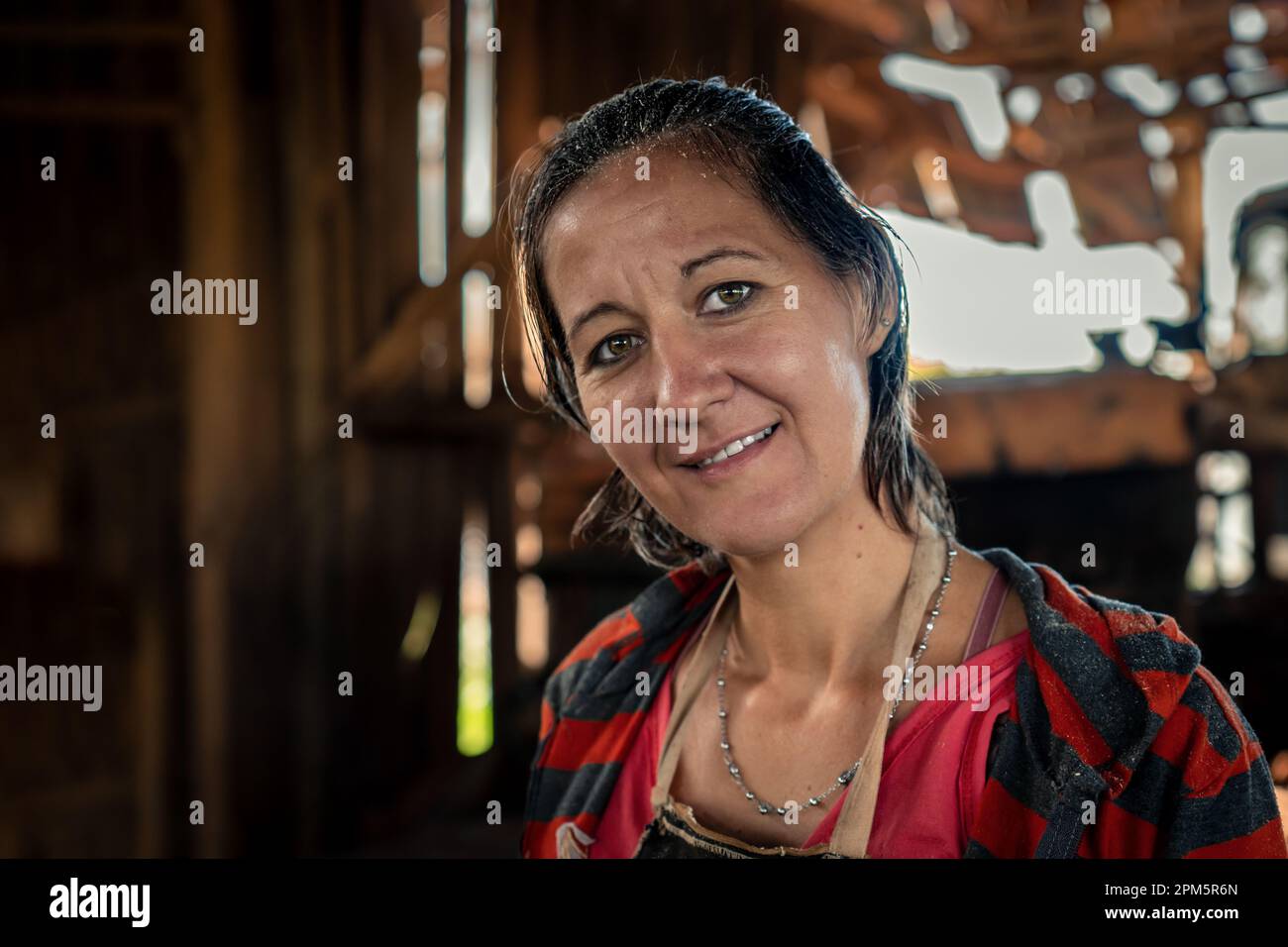 Close-up of a woman working in a factory. Portrait of an adult ...