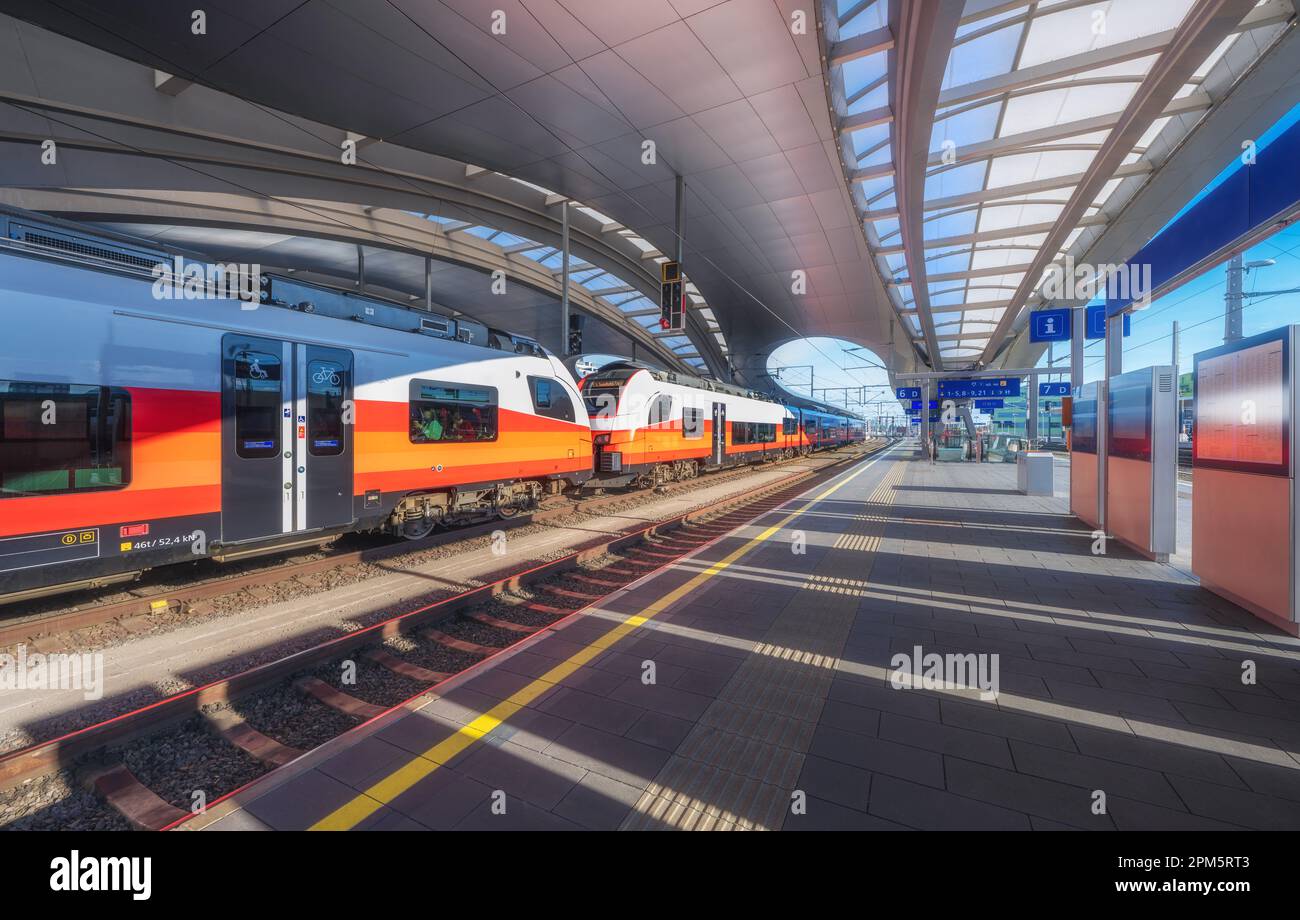 High speed train on the modern railway station at sunset Stock Photo - Alamy