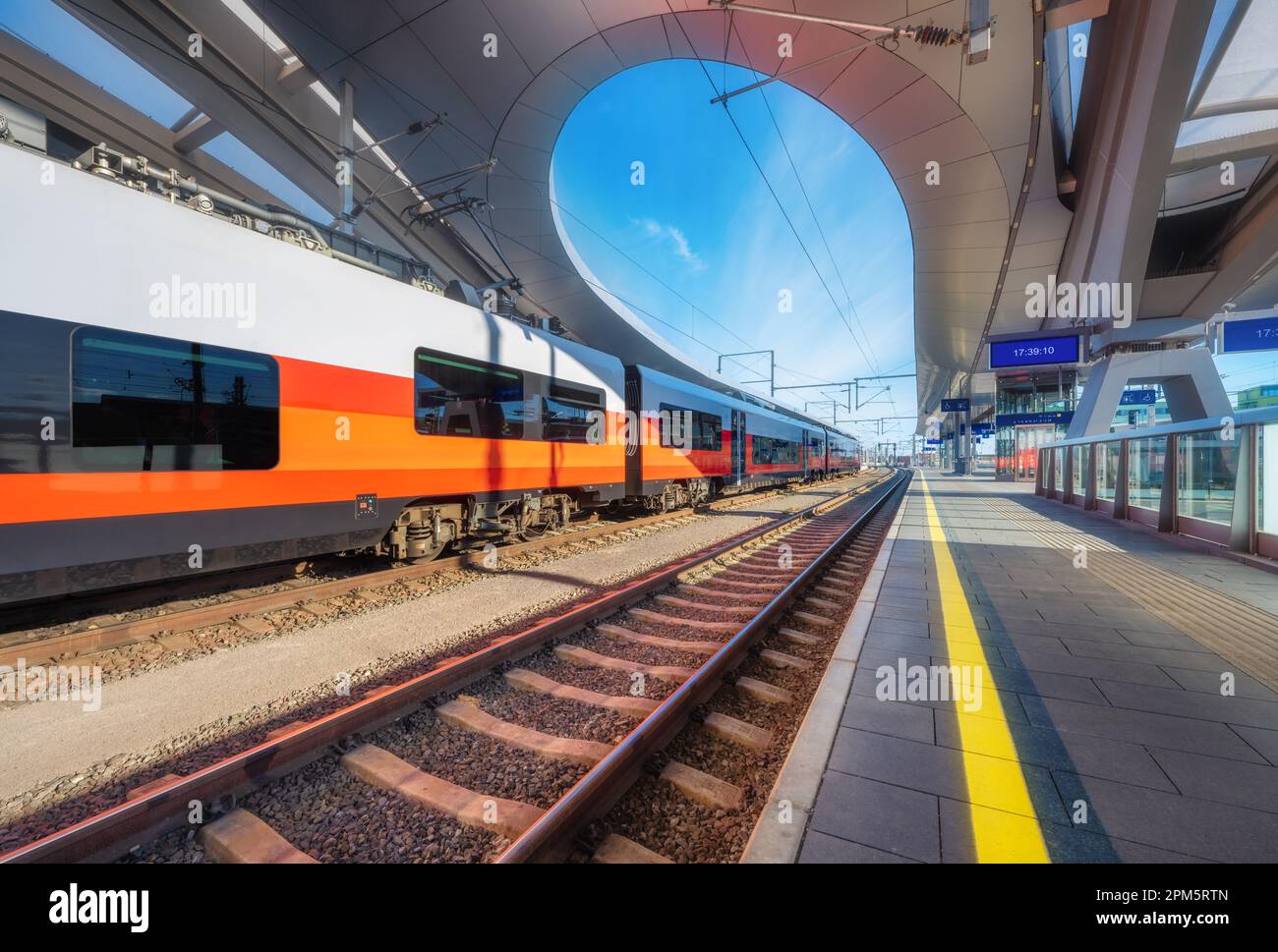 High speed train on the modern railway station at sunset Stock Photo - Alamy