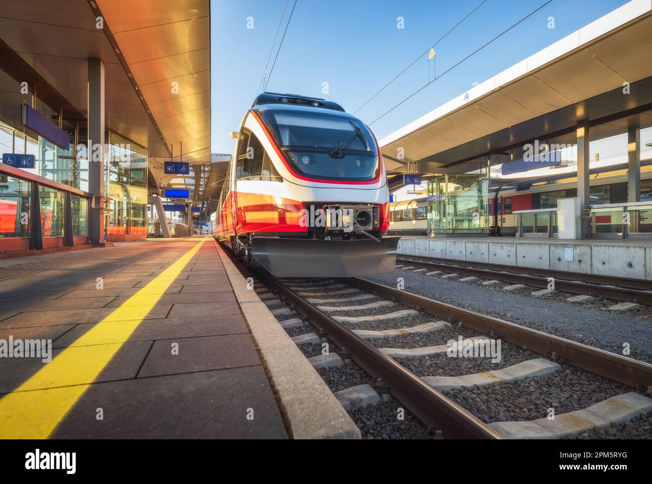 High speed train on the modern railway station at sunset Stock Photo - Alamy