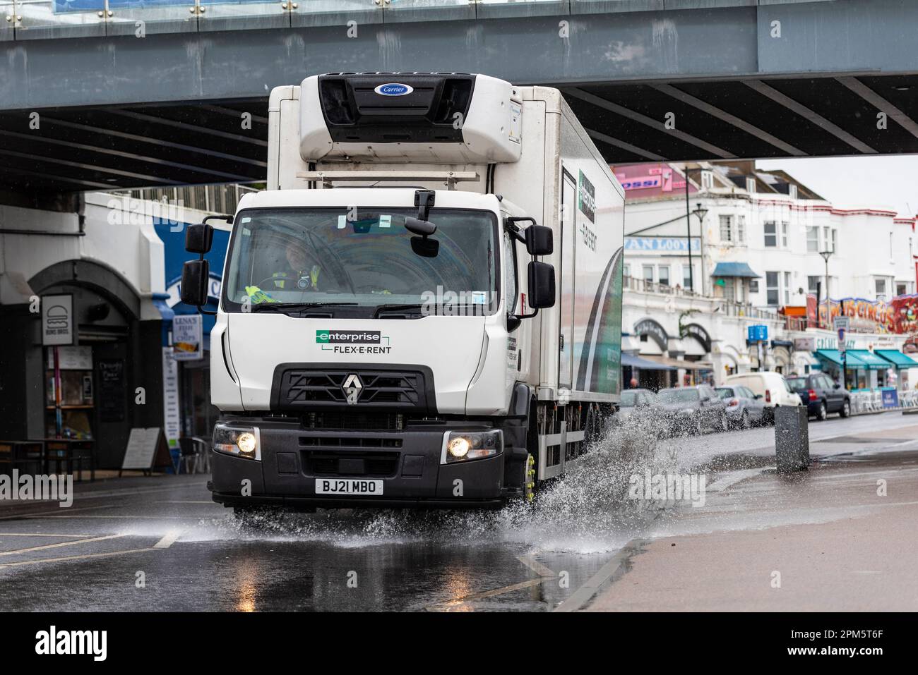 Enterprise Flex E Rent hire lorry driving through rainwater under ...