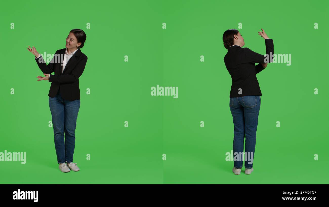 Corporate employee in suit doing advertisement over full body green ...