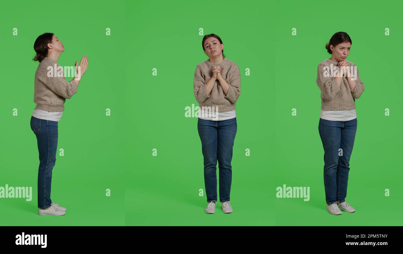 Female model doing prayer hands sign on full body greenscreen backdrop ...