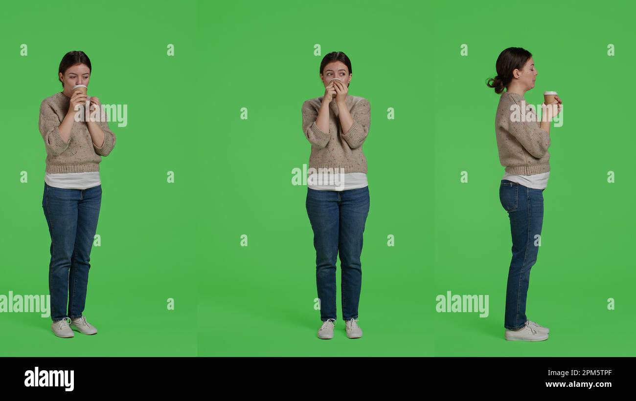 Cheerful person drinking cup of coffee over full body green screen ...