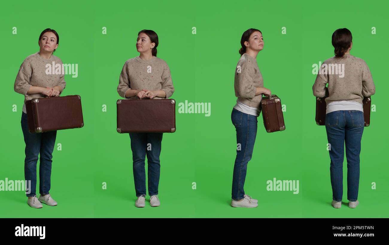 Female model holding suitcase baggage on camera, preparing to leave on ...